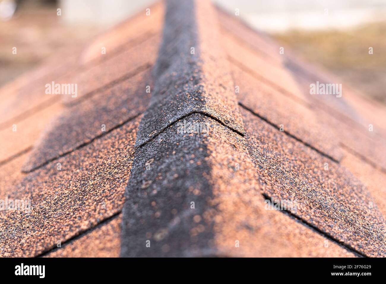 Roofing ridge made of brown bitumen shingles close-up Stock Photo - Alamy