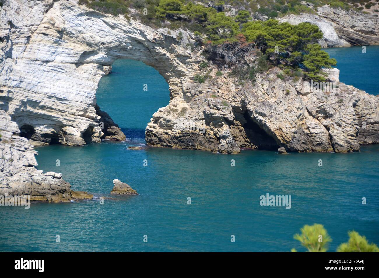 Natural coastal stone arch in a limestone cliff in a blue sea Stock ...