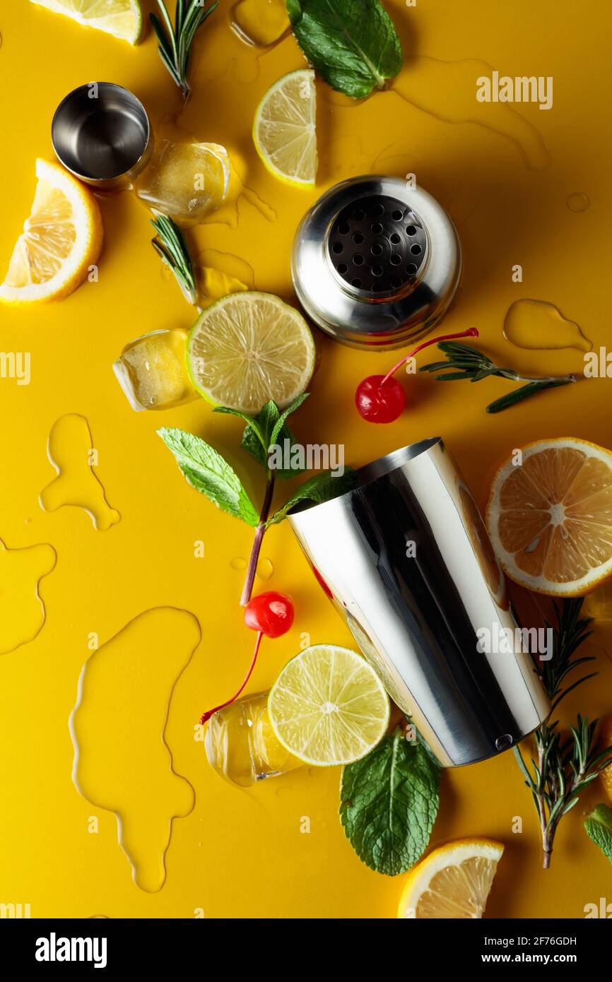 Shaker with ingredients for making cocktails. Yellow background. Top ...