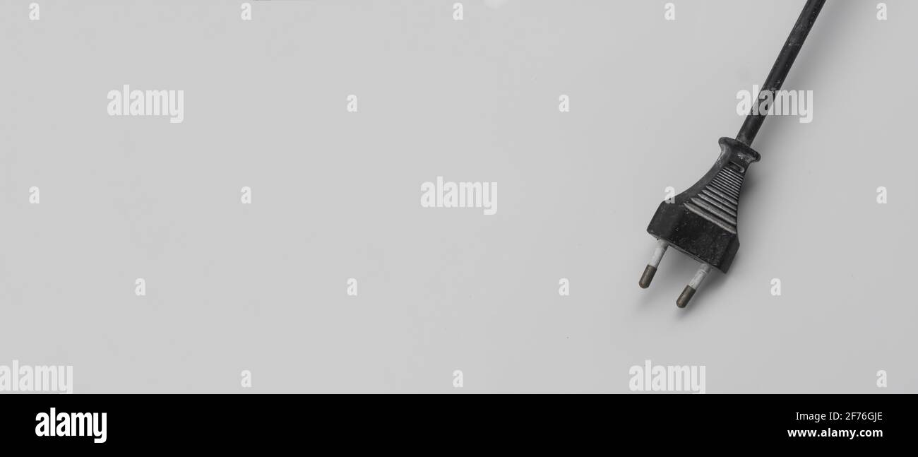 Old dirty black used plug in electricity adapter cable isolated on ...
