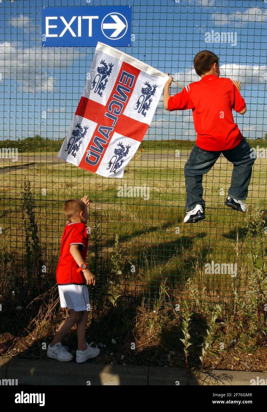 FANS WATCH THE PLANE BRINGING THE ENGLAND FOOTBALL TEAM HOME ,TAXI PAST ...