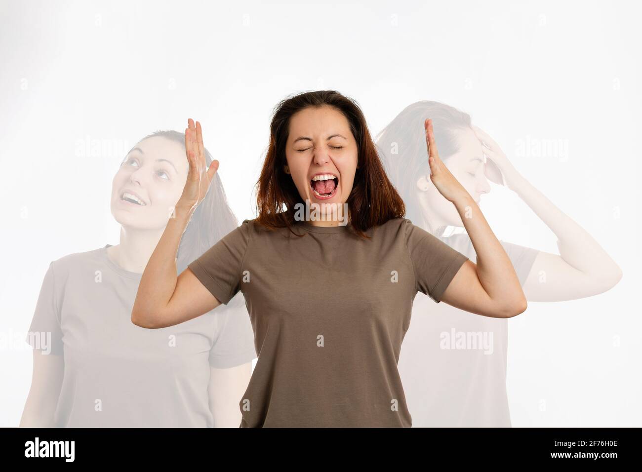 A young woman screams, arms outstretched. On a white background, the ...