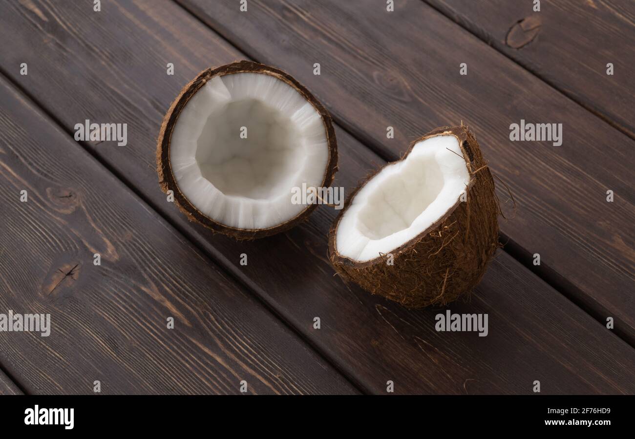 split coconut on wooden planks. Coco, ripe palm fruit. outside of the ...