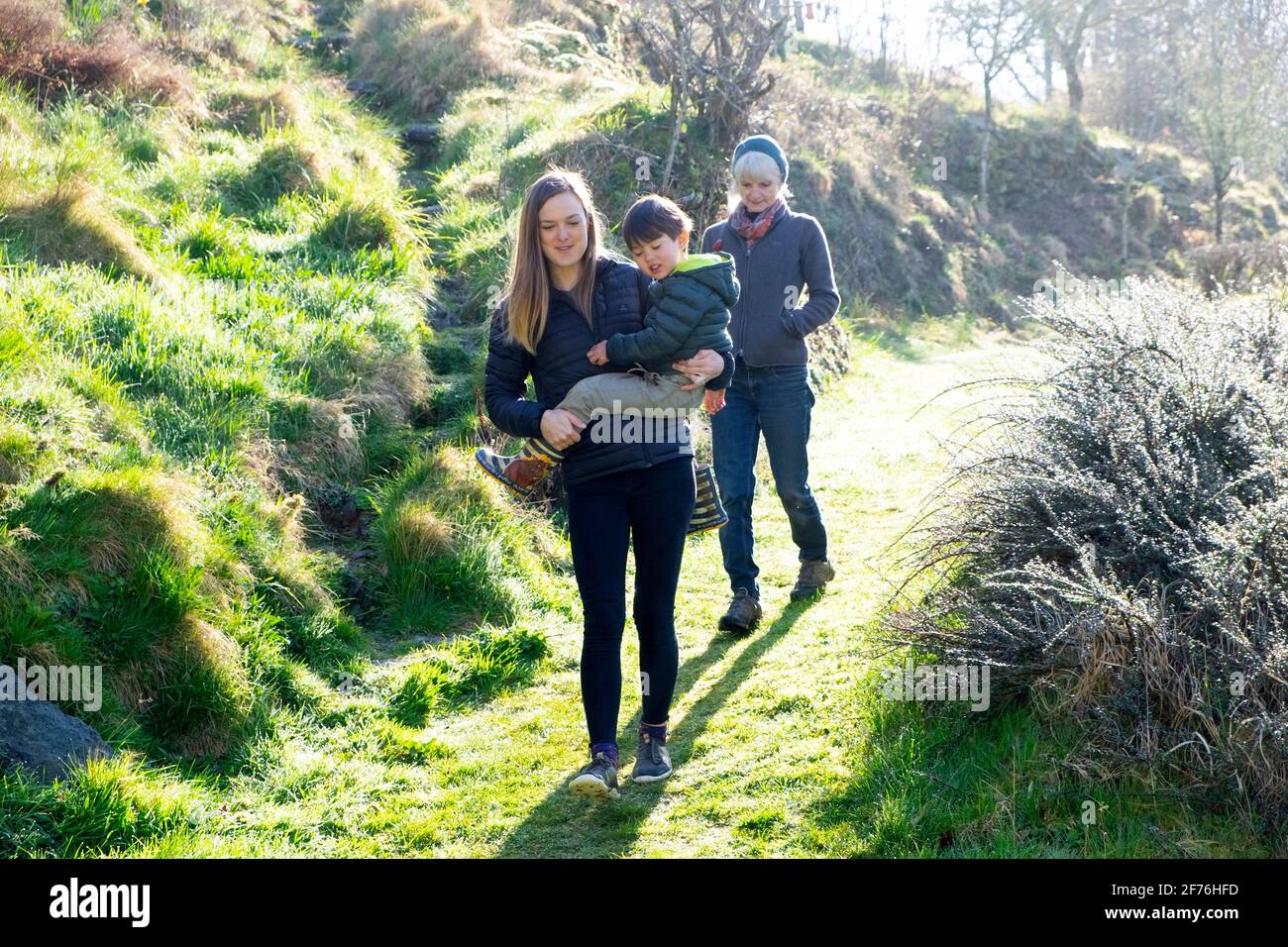Women walking on a path in the rural Welsh countryside in April spring ...