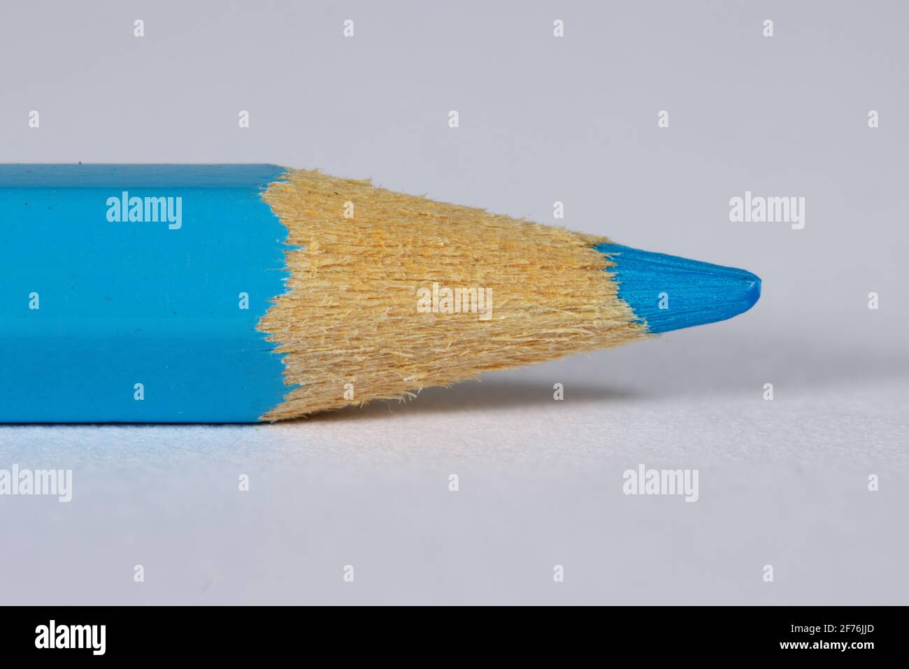 Light Blue sharpened pencil point to the left on a white background ...