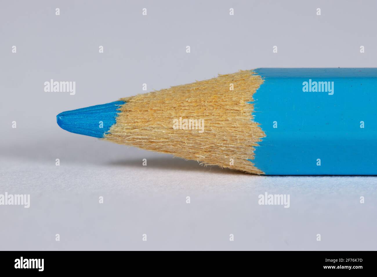 Light Blue sharpened pencil point to the right on a white background ...