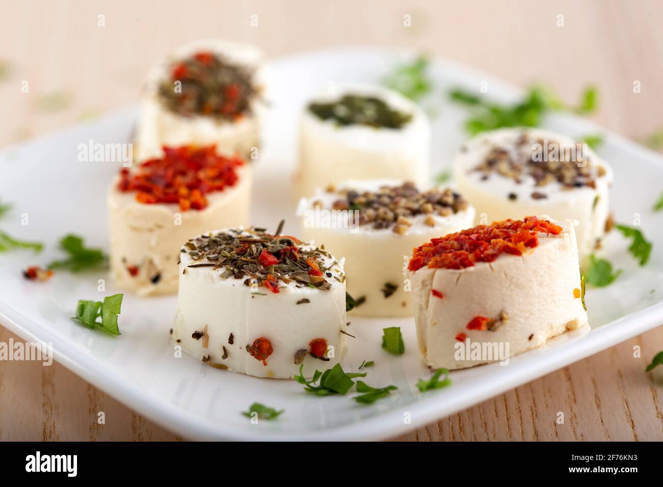 Small cheese appetizers with herbs and dried vegetables Stock Photo - Alamy