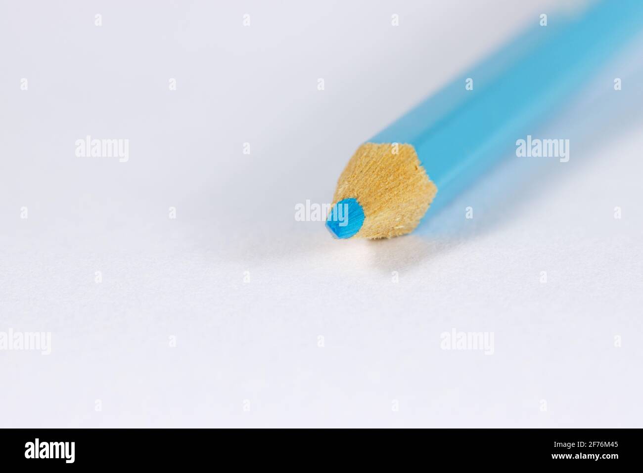 Light Blue sharpened pencil point to the right on a white background ...