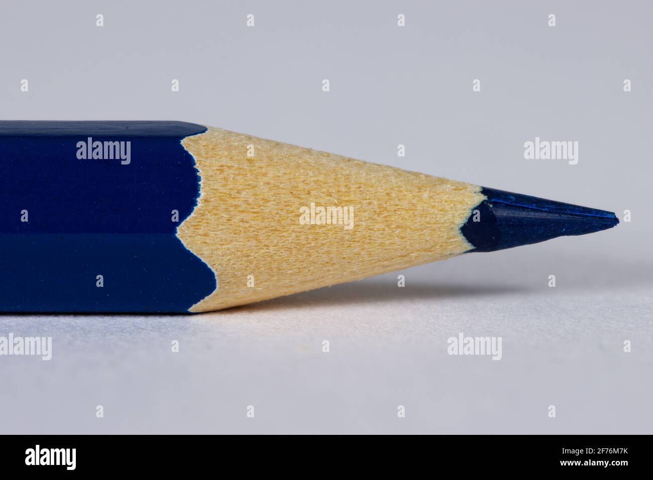 Dark Blue sharpened pencil point to the left on a white background ...