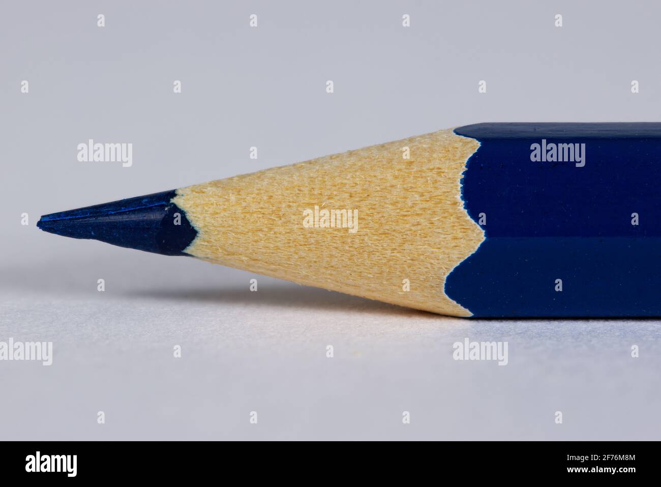 Dark Blue sharpened pencil point to the right on a white background ...