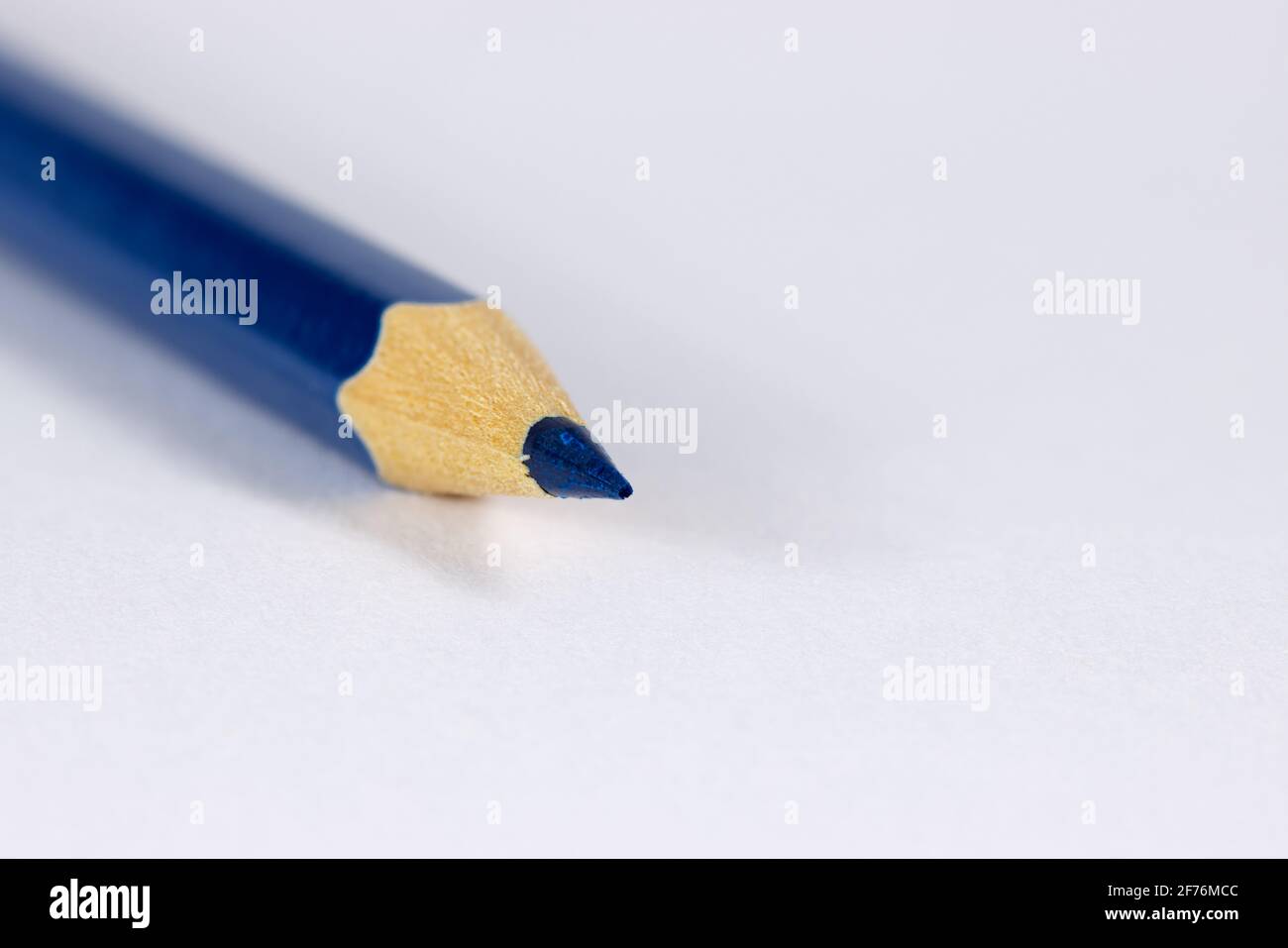 Dark Blue sharpened pencil point to the left on a white background ...