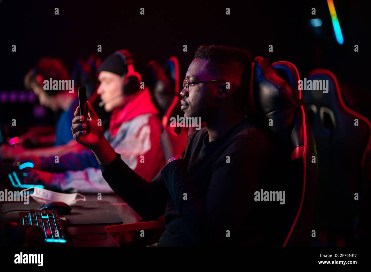 A black streamer leads a live broadcast on the phone from an esports ...