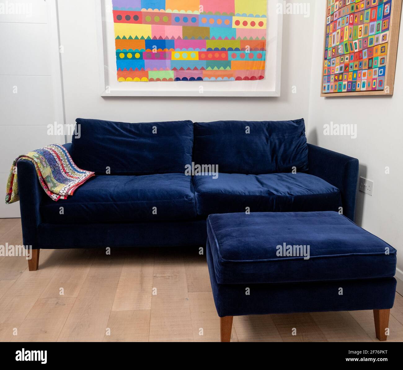 Comfortable blue velvet sofa with matching blue velvet footstool and ...