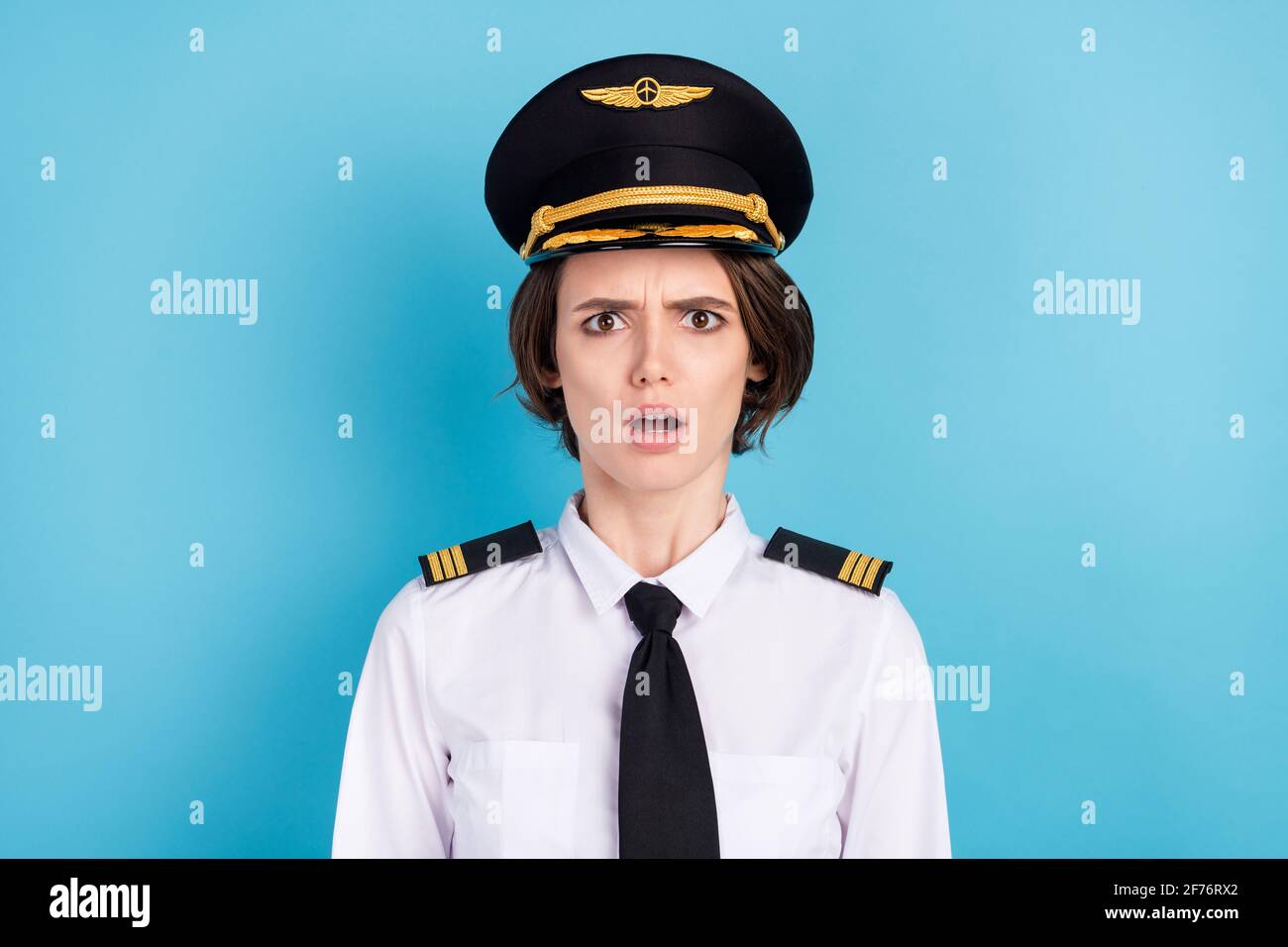 Photo of impressed nice brunette hair lady wear pilot uniform isolated ...