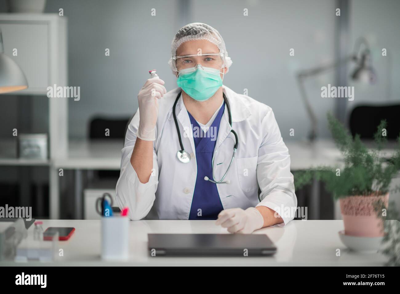 The attractive head of the medical department in his clinic shows the ...