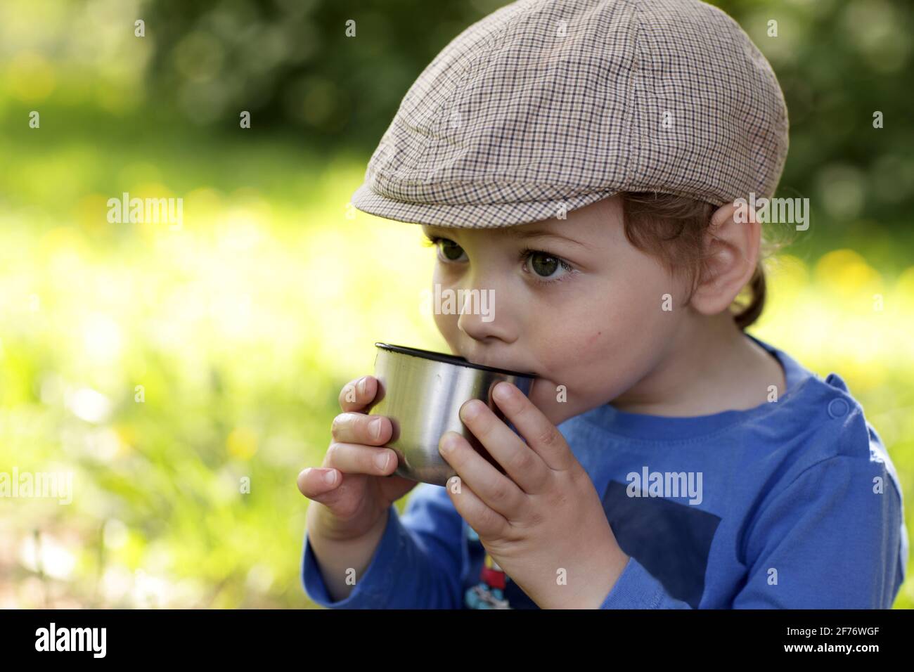 Boy drinking tea in the summer park Stock Photo - Alamy