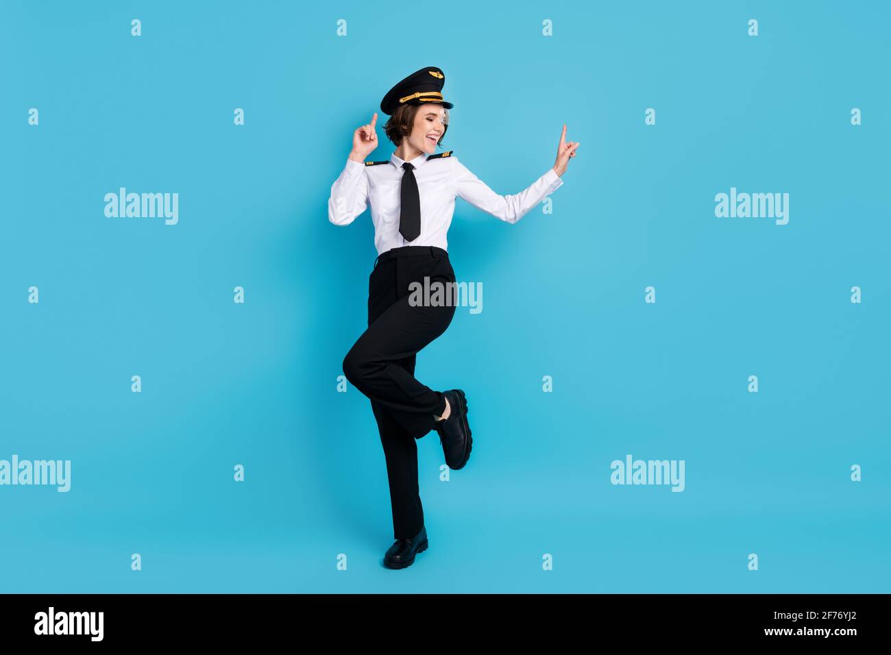 Full length photo of funky happy woman wear pilot uniform dance ...