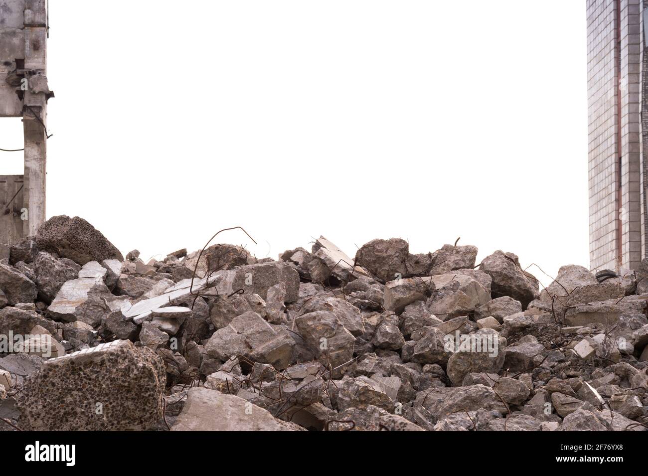 A pile of construction debris and large concrete wreckage against the ...
