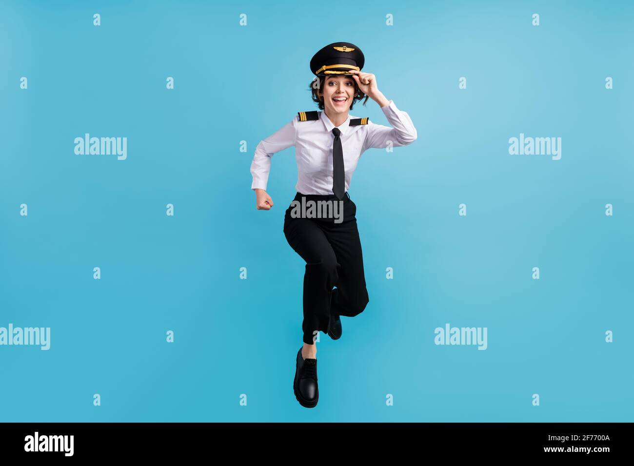 Full length photo of fast happy young woman jump up runner fly pilot ...