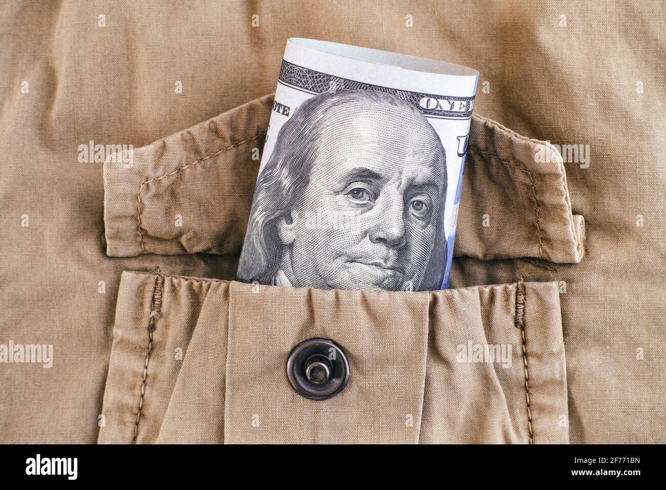 A 100 dollar bill in the pocket of a beige jacket Stock Photo - Alamy