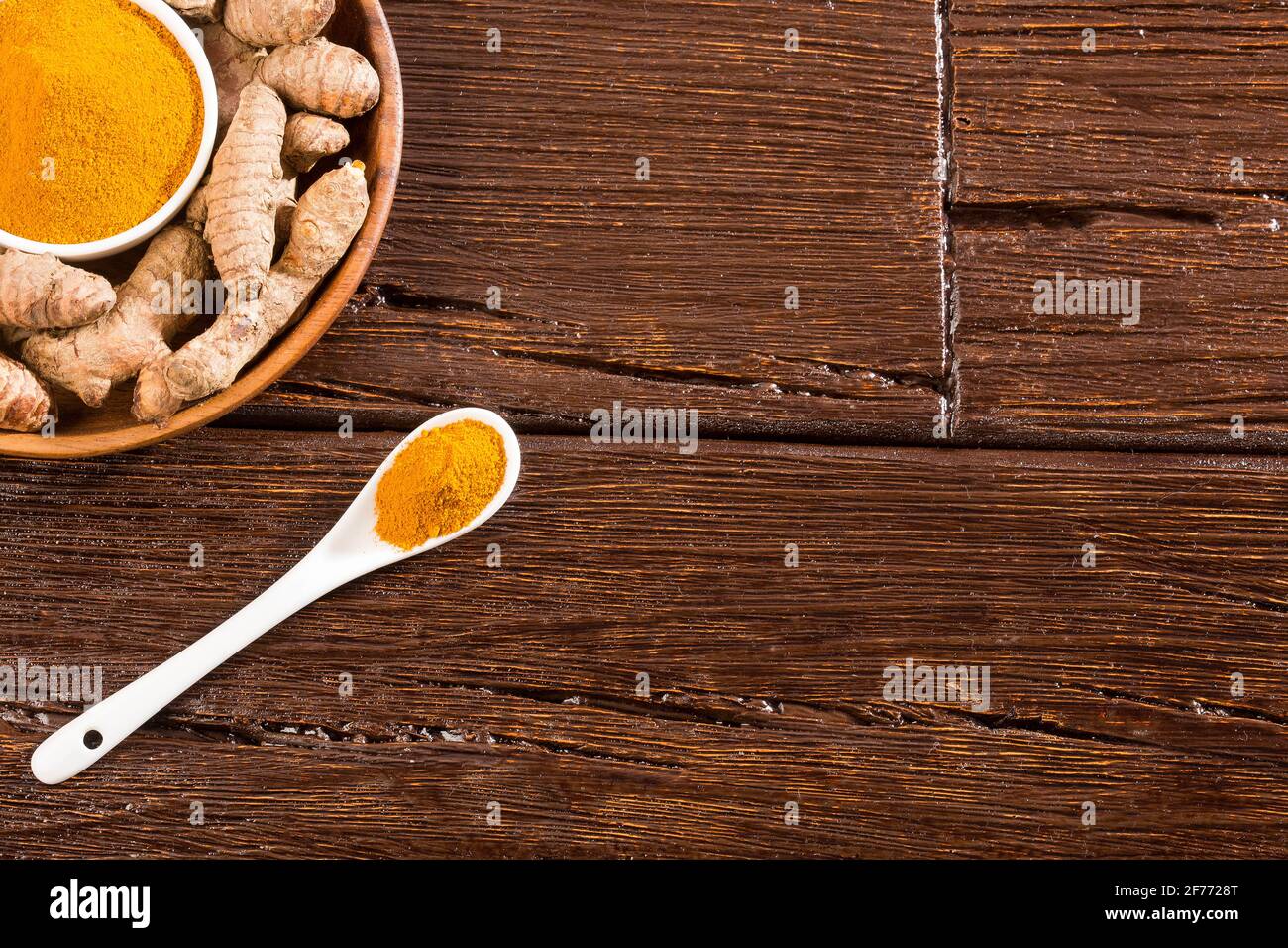 Turmeric powder and fresh turmeric - Top view Stock Photo - Alamy