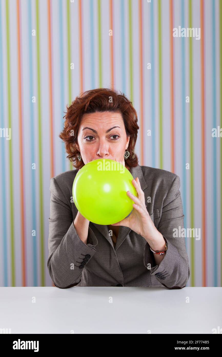 Woman inflating balloon hi-res stock photography and images - Alamy