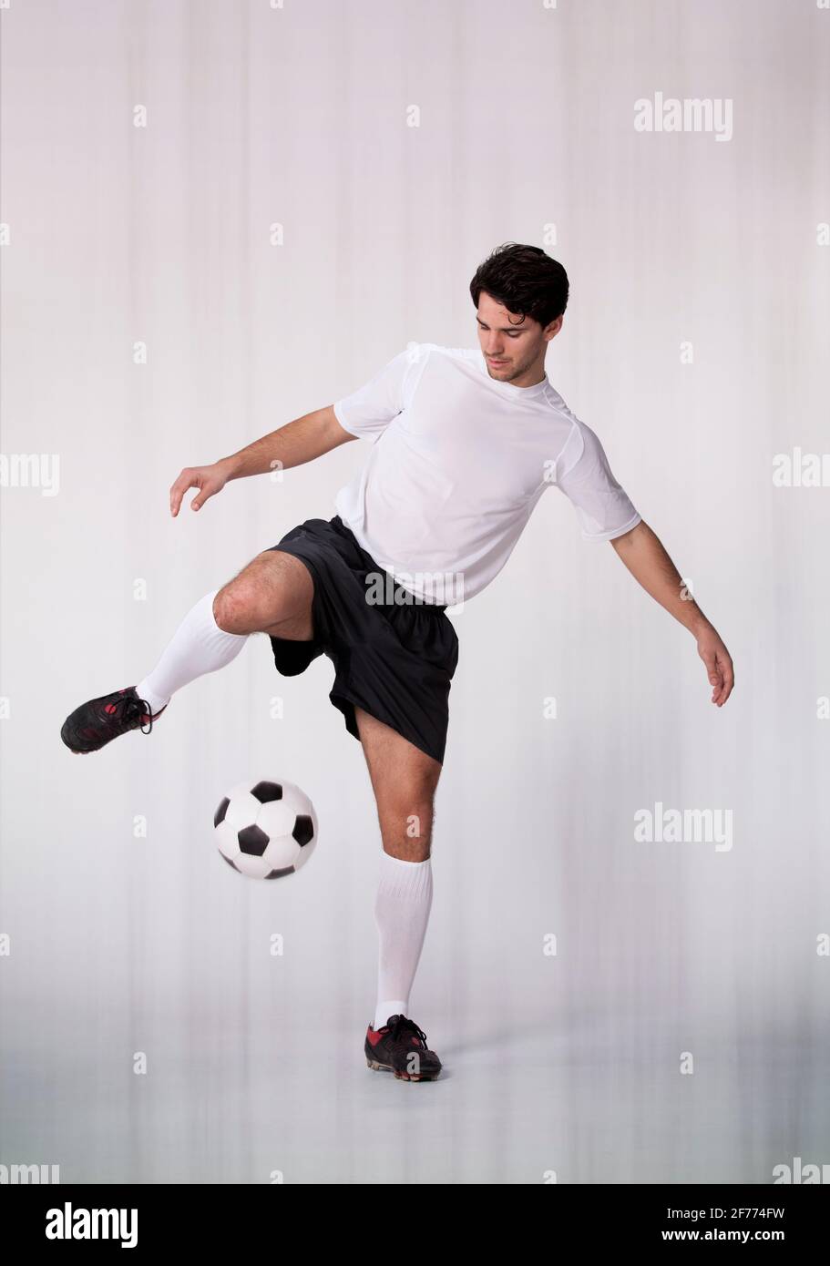 Soccer player with a soccer ball Stock Photo - Alamy