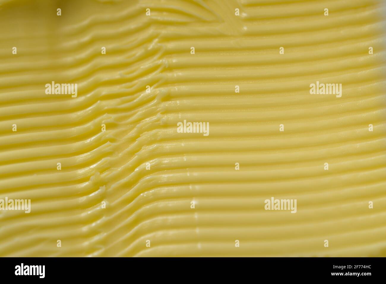 Super macro image of spreadable yellow margarine, after having a ...