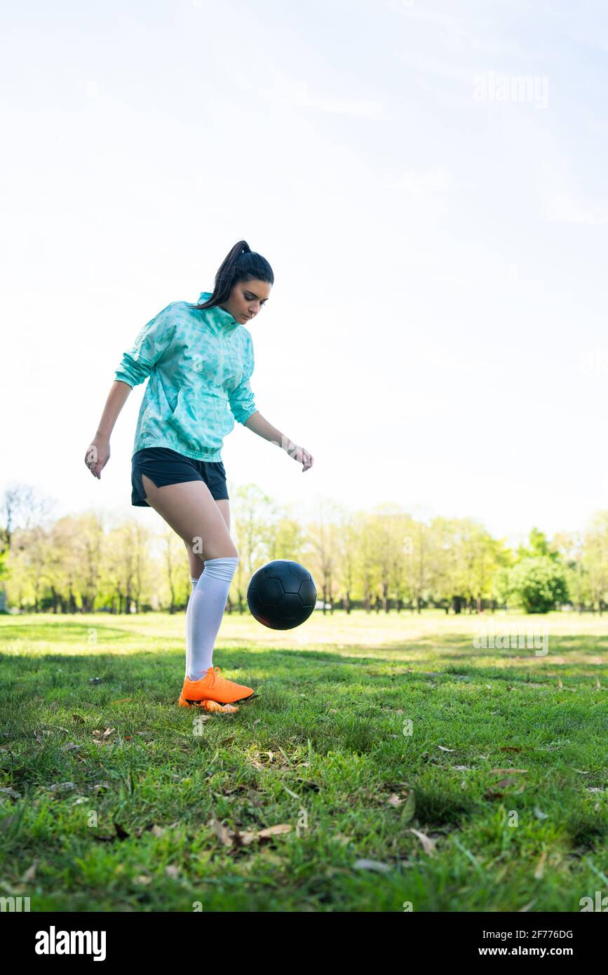 Female athlete is practicing her soccer skills hi-res stock photography ...