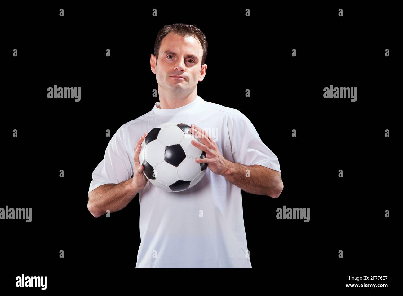 Confident sportsman holding soccer ball hi-res stock photography and ...