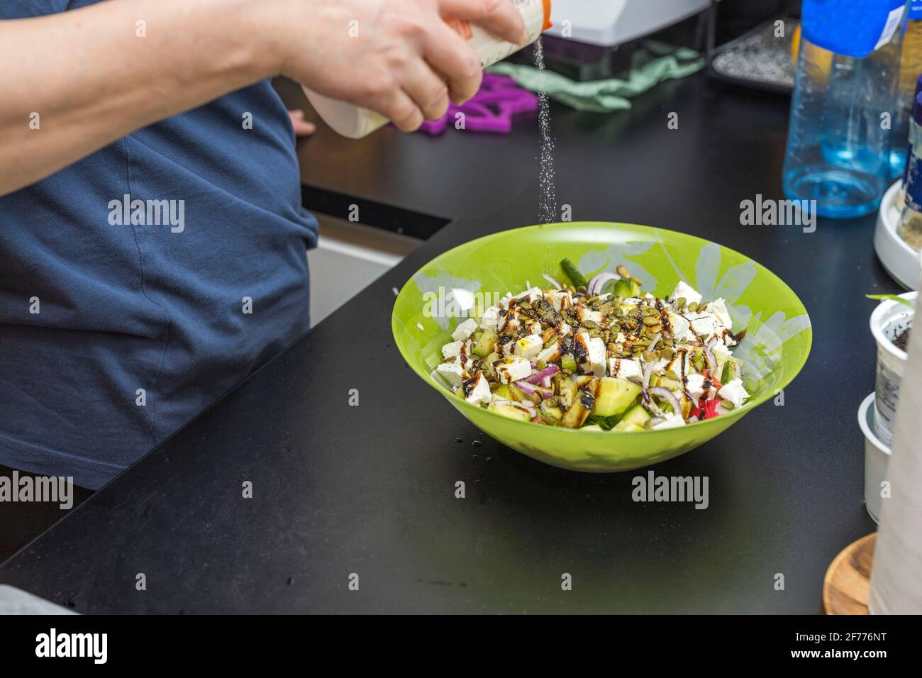 Woman adding salt to food hi-res stock photography and images - Alamy