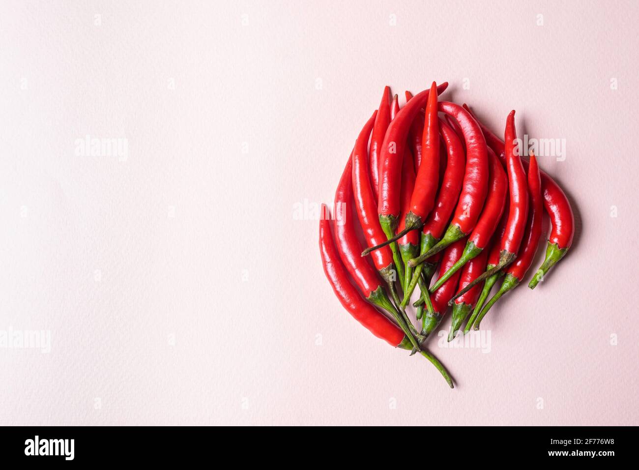 A slide of red chili peppers on a light background. View from above ...