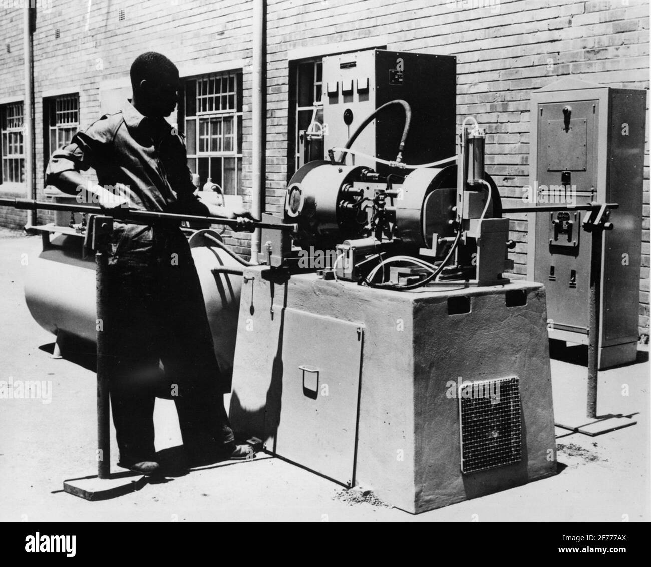 A shock carrier is led into one end of an electrolytic grinder while ...