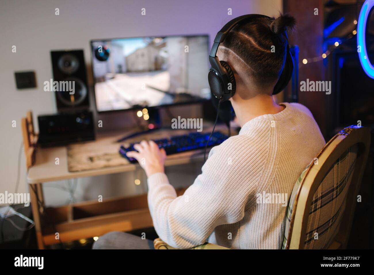 Men playing online video games at home using powerful computer ...