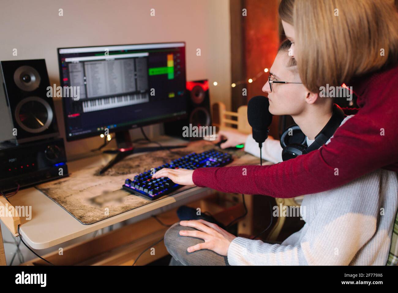 Woman put finger on keyboard and help for man in his work. Process of ...