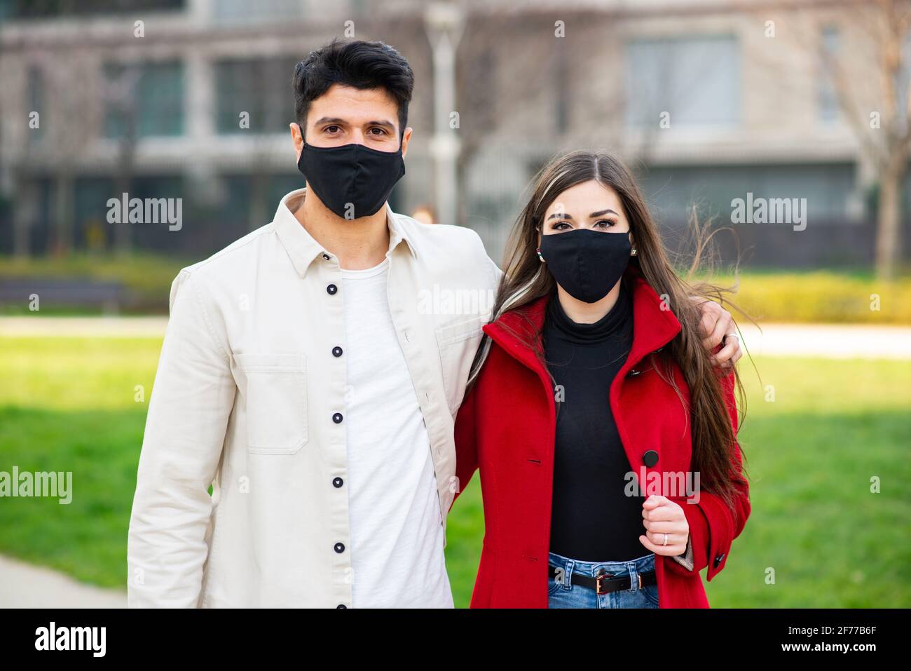 Portrait of a young couple wearing masks, covid and coronavirus concept ...
