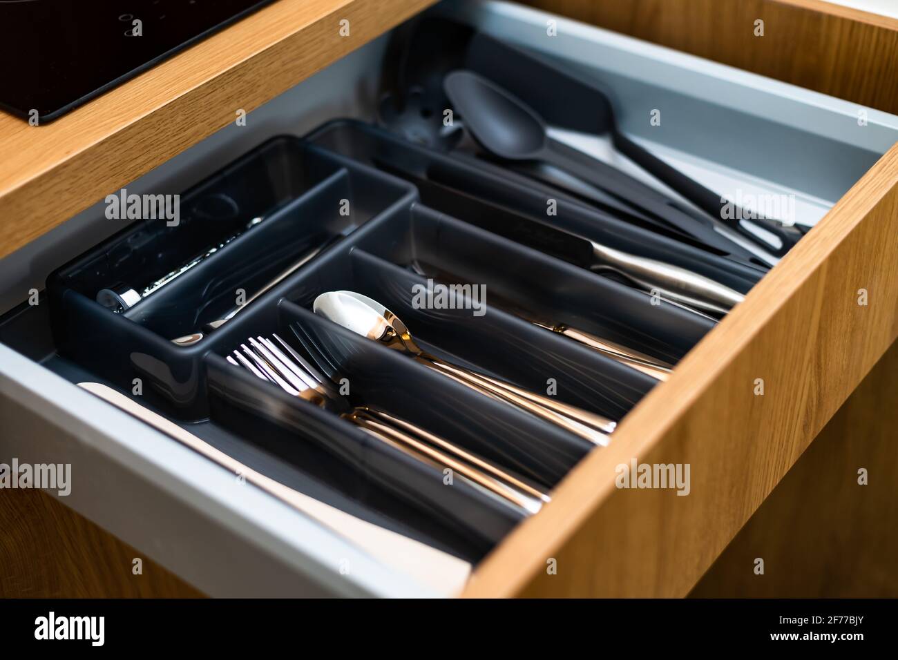 Kitchen box with cutlery. Spoons, forks, knives, pots Stock Photo - Alamy