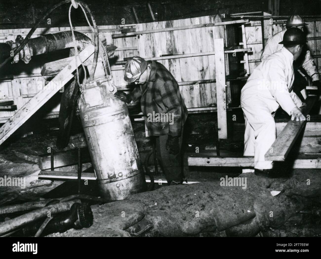 Workers at an American rocket base lowering a flight pump to the ...