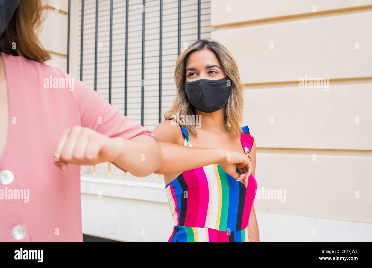 Two friends bumping elbows hi-res stock photography and images - Alamy