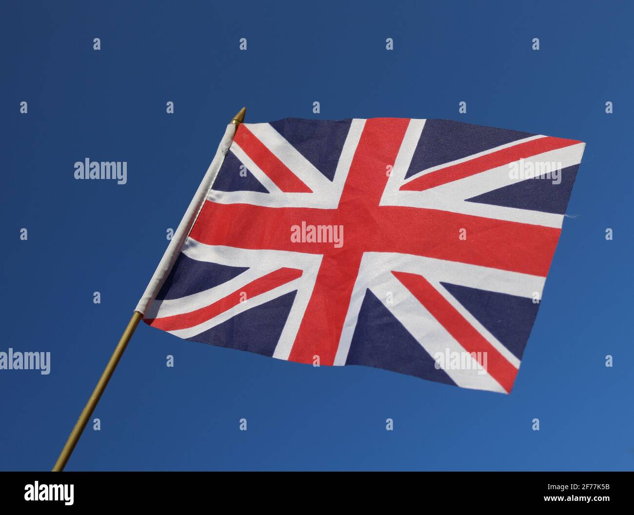 UK flag, Union Jack flying over a blue sky Stock Photo - Alamy