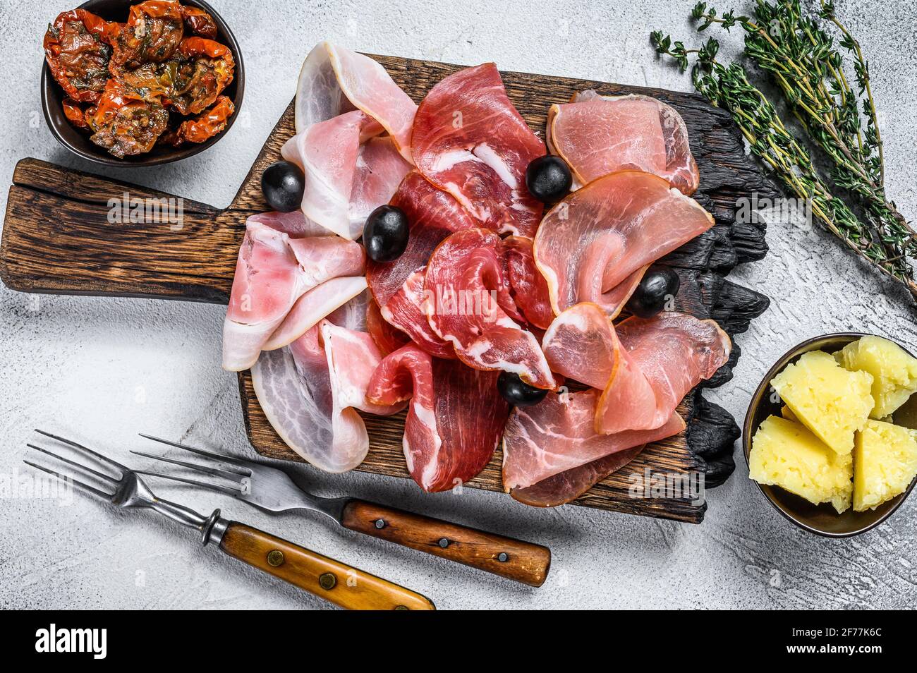 Cured meat platter of traditional Spanish tapas. White background. Top ...