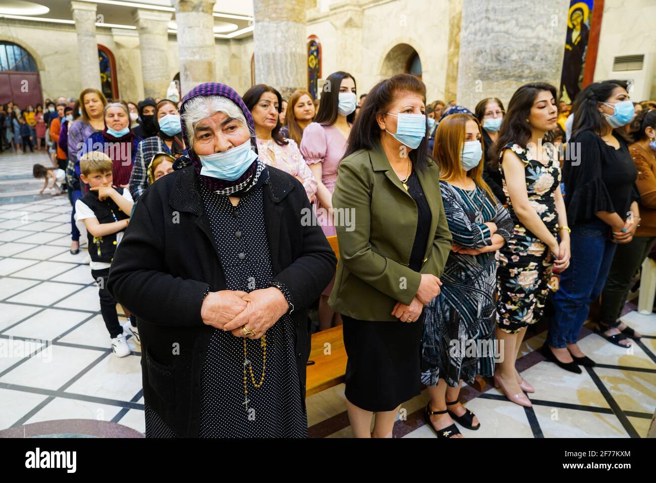 Iraqi Christians attend the Easter mass at the Grand Immaculate Church ...