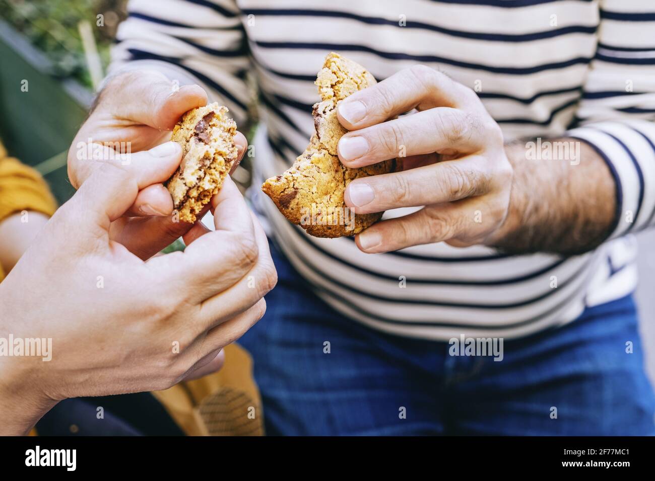 Sharing chocolate hand hi-res stock photography and images - Alamy