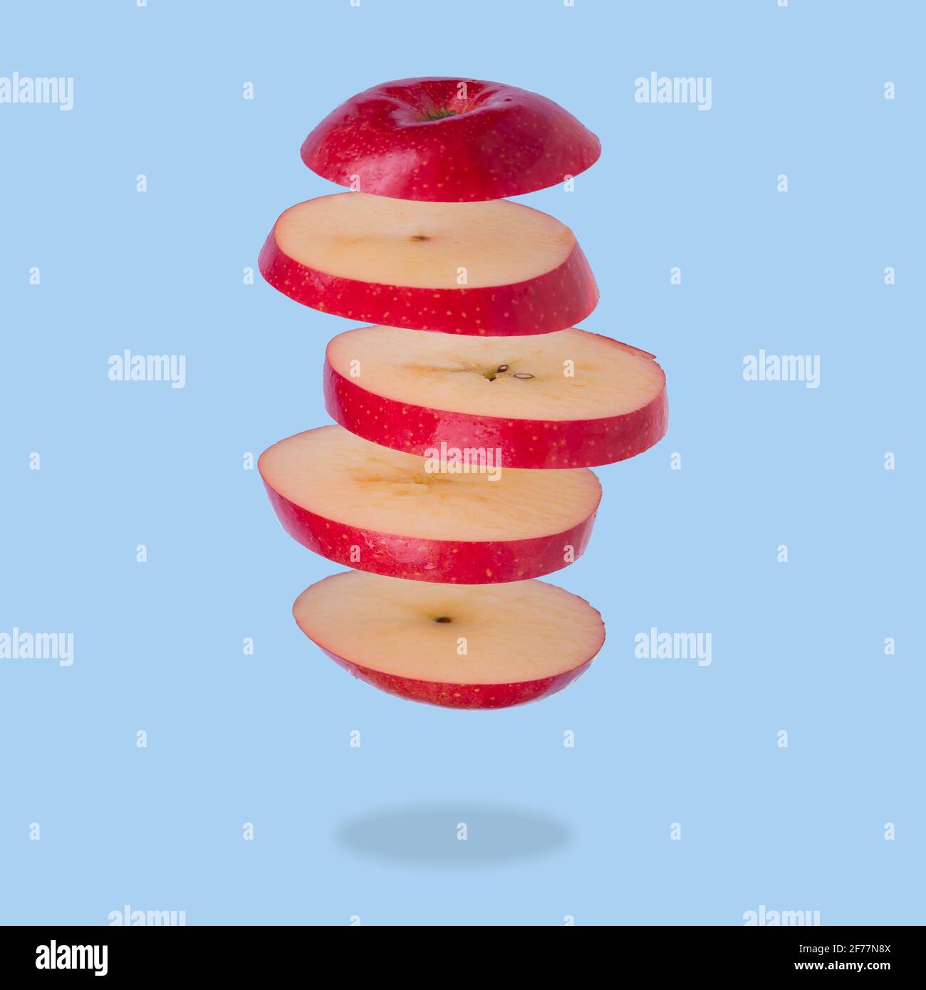 Floating levitating ripe apple on a blue background. Vitamins, healthy ...