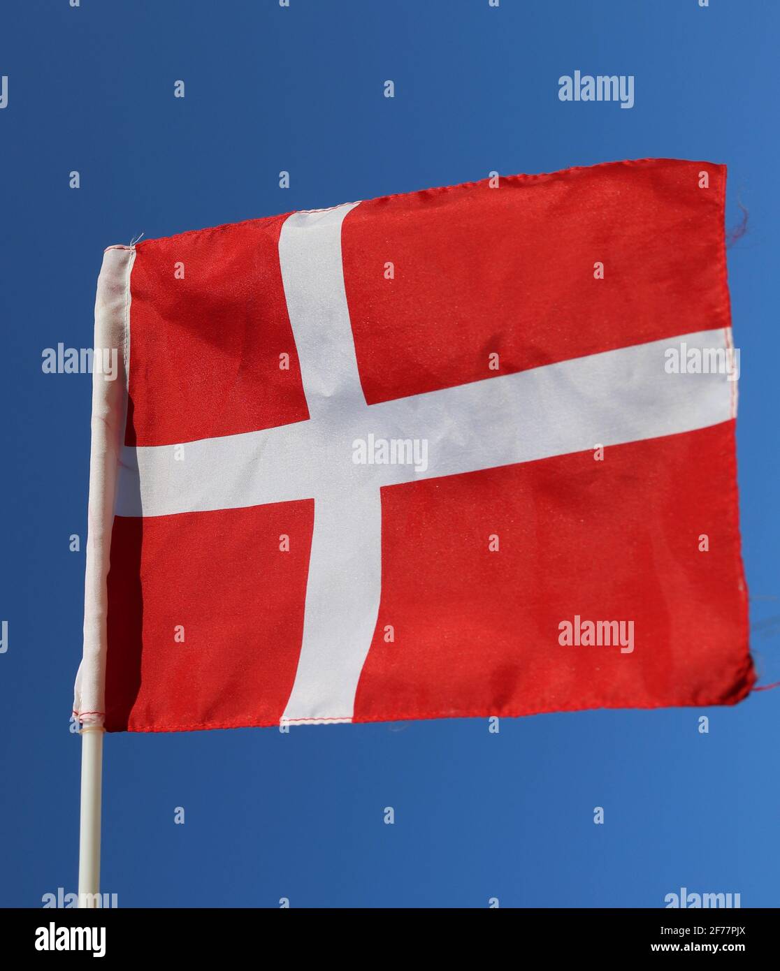 Flag of Denmark flying over a blue sky Stock Photo - Alamy
