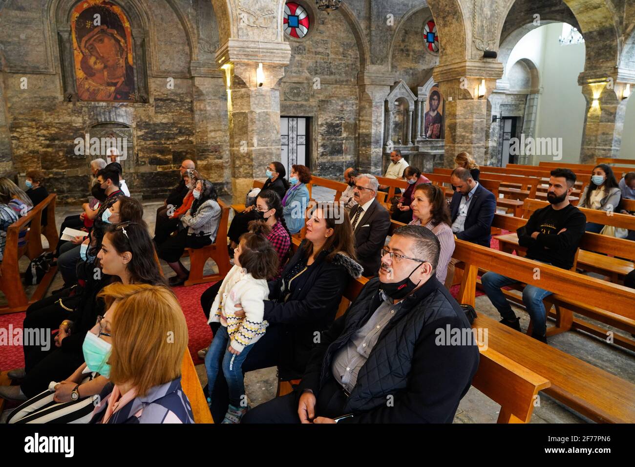 Iraqi Christians attend the Easter mass at the Grand Immaculate Church ...