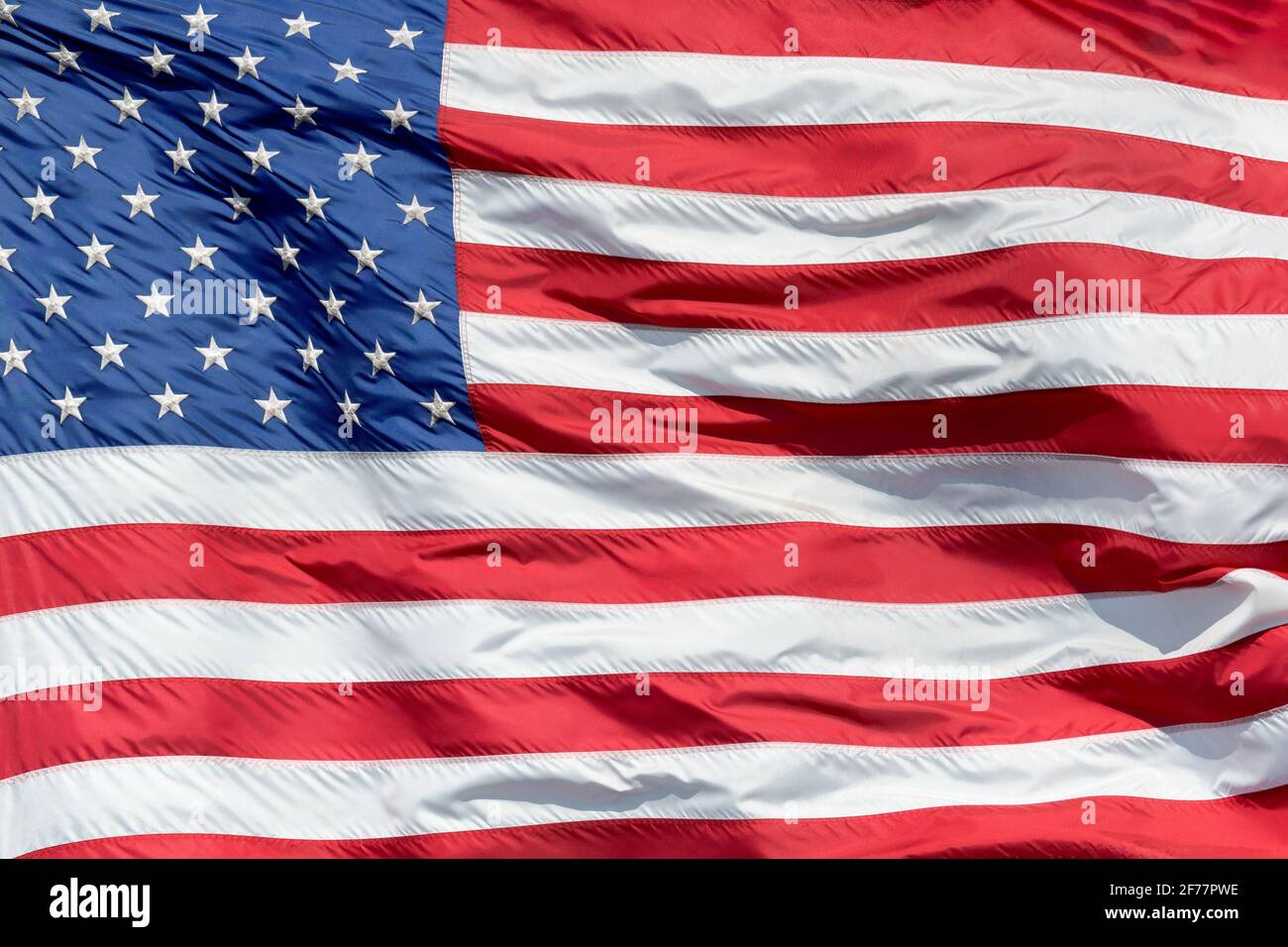 Red flag waving in strong hi-res stock photography and images - Alamy