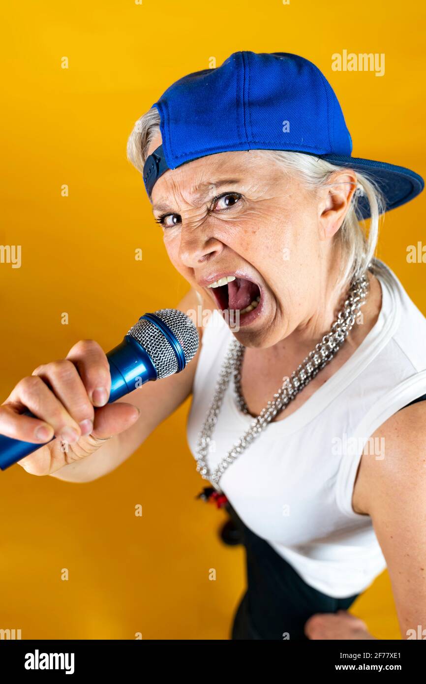 Funny portrait of mature woman. Lady having fun dressed as an angry ...