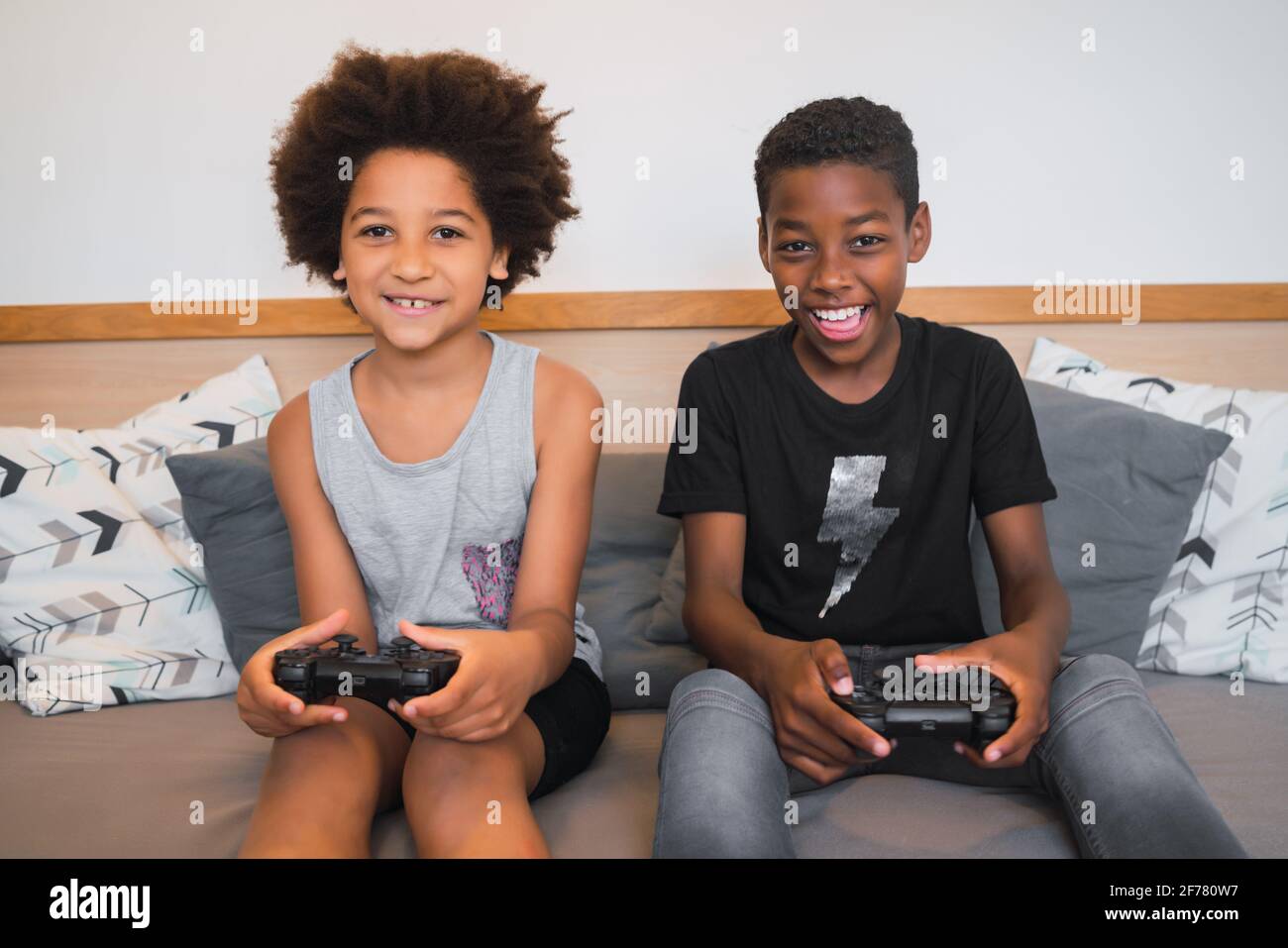 Two brothers playing video games at home Stock Photo - Alamy
