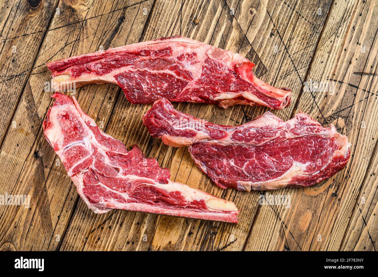 Various cuts of raw beef meat. Wooden background. Top view Stock Photo ...
